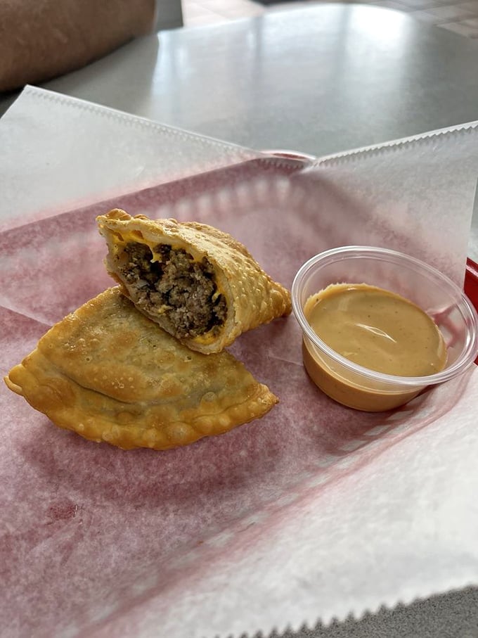 Golden empanadas with that perfect crimped edge—like little treasure chests filled with savory goodness instead of doubloons. The dipping sauce is non-negotiable.