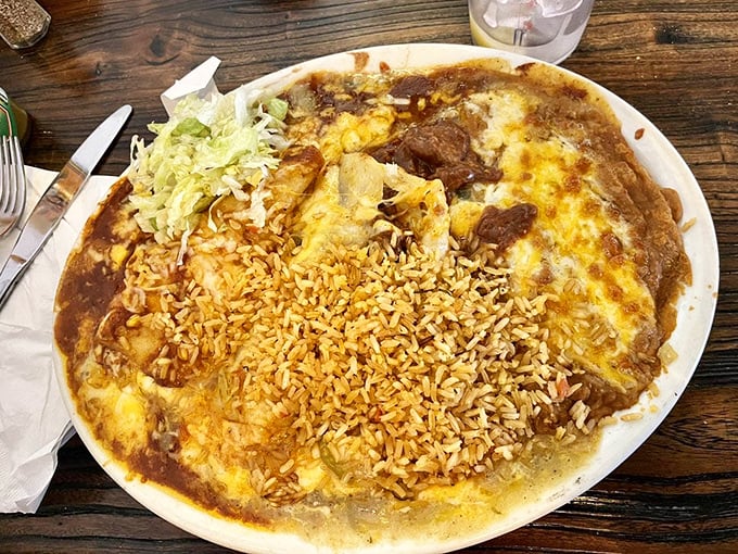 Enchiladas swimming in sauce with a life raft of rice—the kind of plate that makes you want to cancel your afternoon plans.