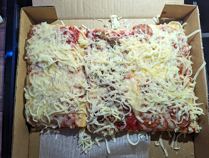 The uncooked pizza awaits its transformation – like watching Superman before he enters the phone booth, you know greatness is just minutes away.