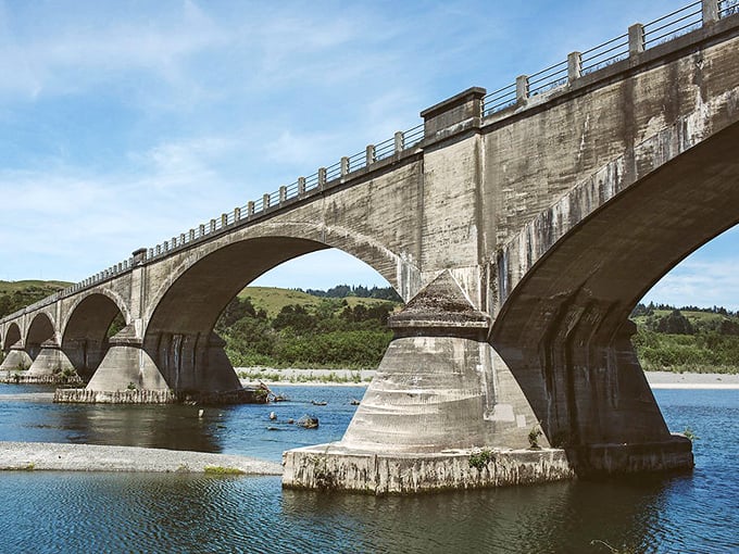 The historic Fernbridge spans the Eel River like a concrete poem—each arch a stanza connecting Ferndale to the modern world.