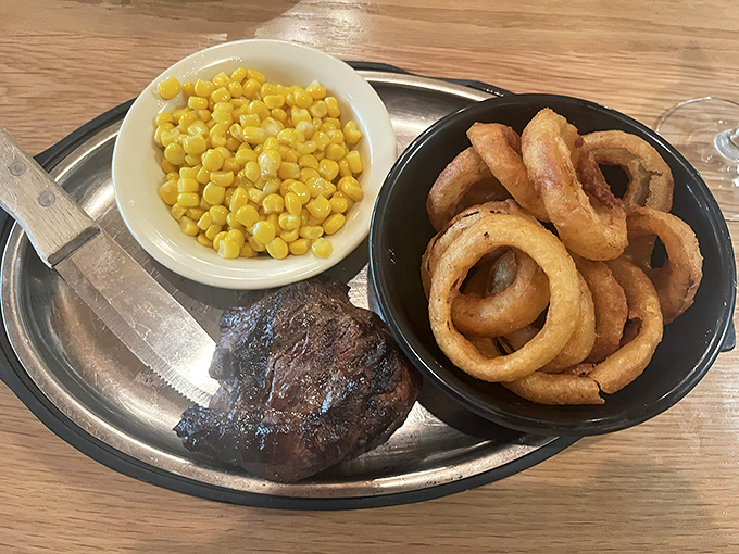 Filet mignon with a side of golden corn and perfectly crispy onion rings. The holy trinity of steakhouse happiness.