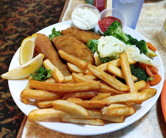 Golden fish and chips that crackle with each bite, served with a vegetable medley that makes you feel virtuous while committing deep-fried sins.