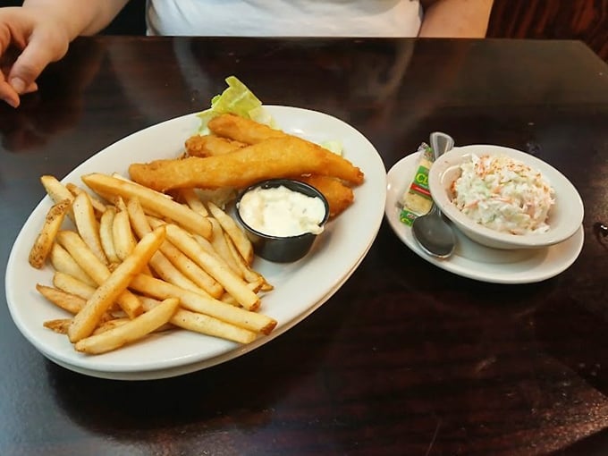 Golden fish and chips with creamy coleslaw—proof that sometimes the simplest pleasures are the most satisfying. Just listen to that perfect crunch!