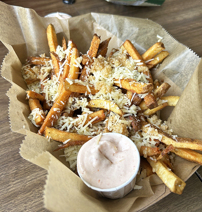 These aren't just fries—they're golden potato treasures dusted with parmesan fairy dust. That dipping sauce isn't an afterthought; it's the supporting actor deserving its own award.