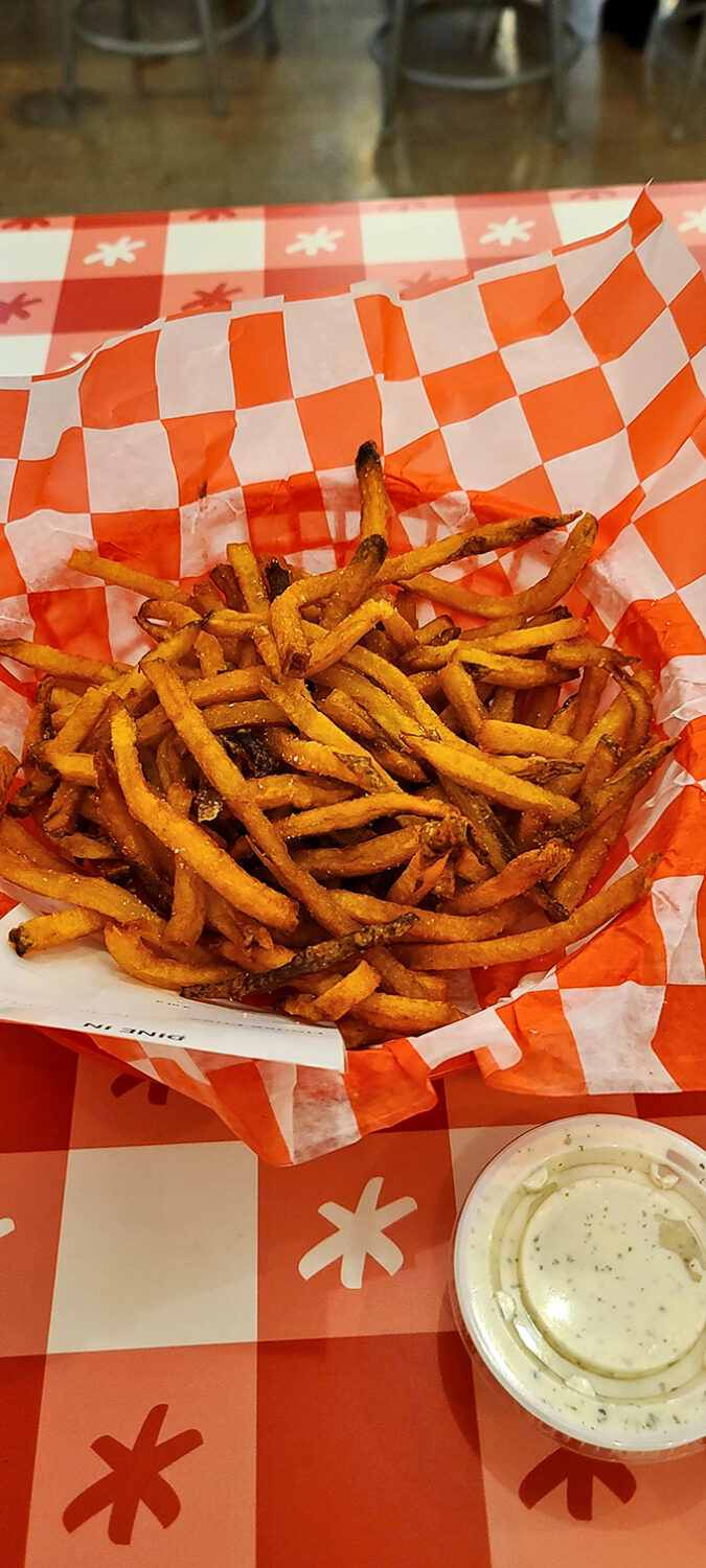 Crispy, hand-cut fries that deserve their own fan club. That little cup of ranch isn't just a condiment—it's a cooling lifeline after the chicken heat.
