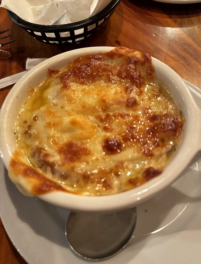 French onion soup that's wearing a golden crown of bubbling cheese – royalty in a crock that's worth every bit of the stringy cheese dance.