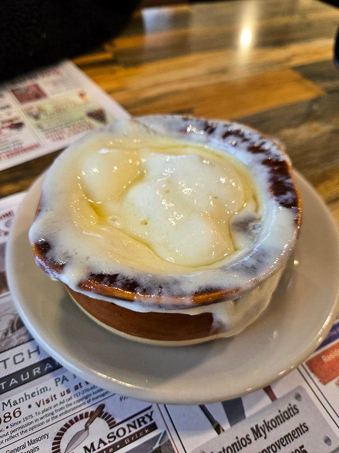 French onion soup that's wearing its cheese like a cozy winter blanket. Comfort in a crock that's worth every spoonful.
