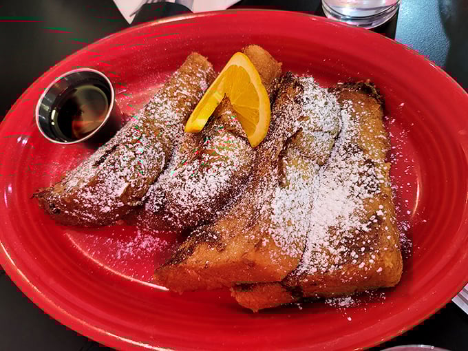 French toast that makes you question all other French toast—dusted with powdered sugar, kissed with butter, and waiting for that maple syrup waterfall.
