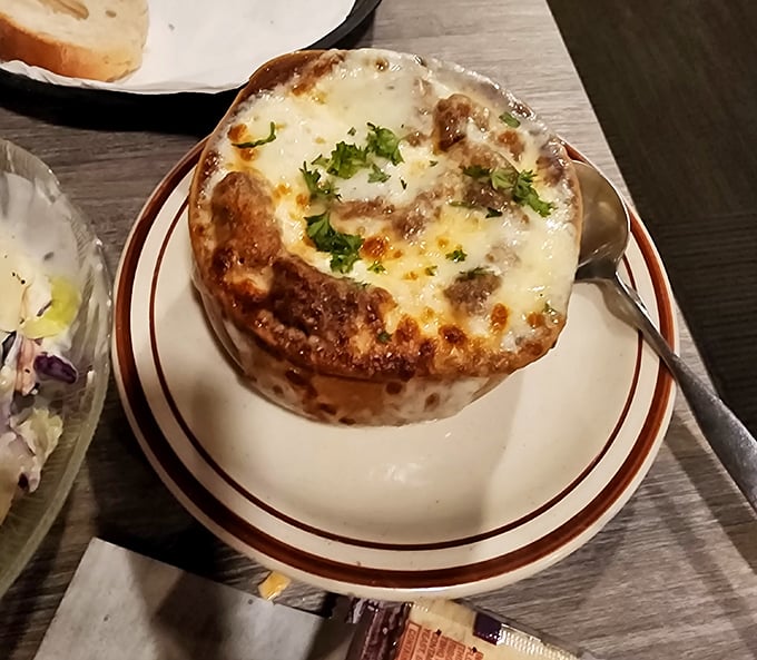 This isn't just French onion soup—it's a bubbling cauldron of cheese-capped comfort that's worth every moment spent untangling the glorious cheese pull.
