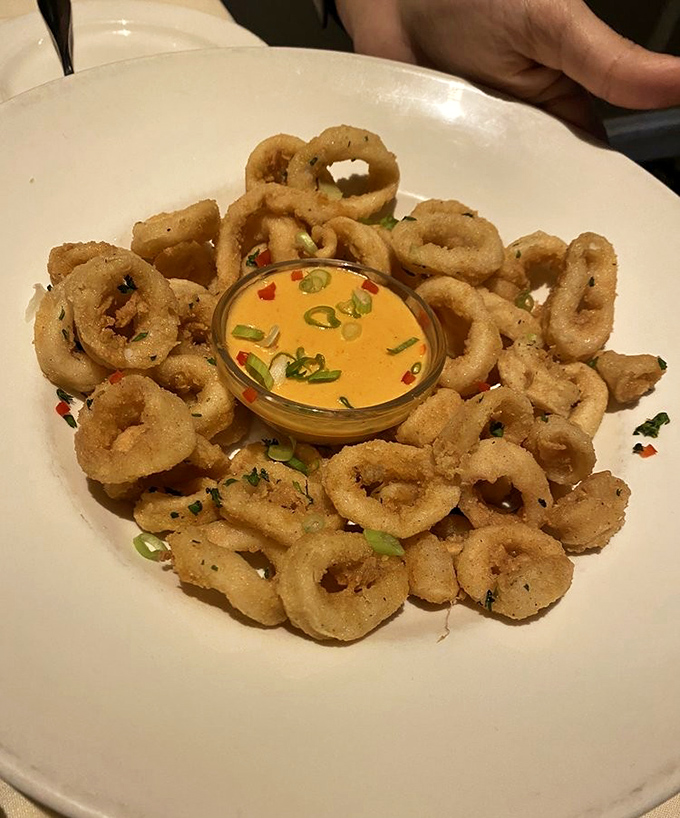 Crispy calamari rings surrounding a vibrant dipping sauce—the seafood equivalent of a perfect halo. Resistance is futile.