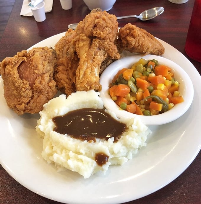 Fried chicken this gloriously golden brown doesn't just happen by accident—it's the result of diner wisdom passed down through generations of breakfast wizards.