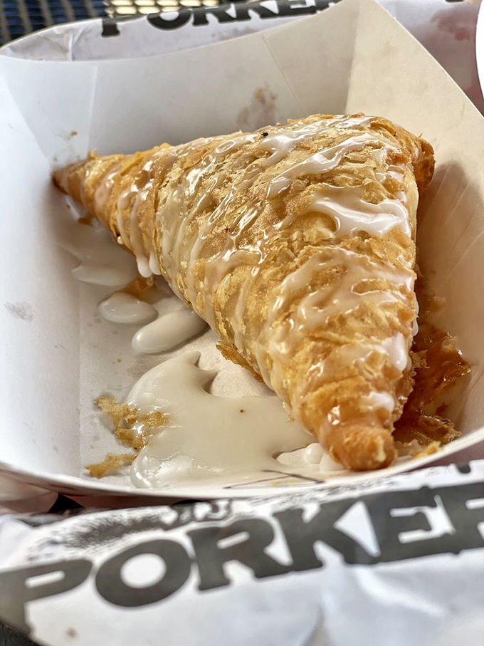 This isn't just dessert—it's a fried pie with glaze cascading down its flaky armor, ready to ambush your diet plans with sweet, sweet treachery.