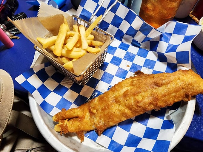 Golden-fried flounder that shatters at first bite, paired with fries served in a miniature wire basket—seafood comfort food elevated to an art form.