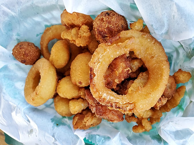 Golden-fried treasures from the deep—where rings, shrimp, and nuggets of seafood have achieved crispy perfection in a single, shareable basket.