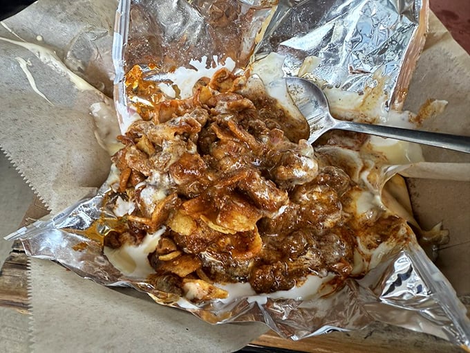 Comfort food engineering at its finest—layers of savory goodness that would make even the most dignified diner lick the foil clean.