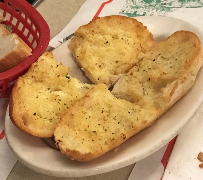 Garlic bread at Luigi's isn't just a side—it's the opening act that deserves its own standing ovation, golden and glistening with herby promise.
