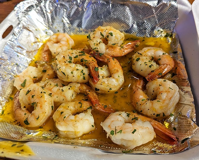 Plump shrimp swimming in a buttery sea of garlic and herbs—proof that sometimes the simplest preparations yield the most profound flavors.