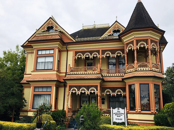 The Gingerbread Mansion isn't just well-preserved—it's downright showing off with its butter-yellow exterior and intricate wooden detailing.