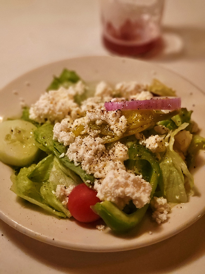 The Greek salad offers a crisp, tangy intermission between rich bites – like the palate-cleansing sorbet of steakhouse dining.