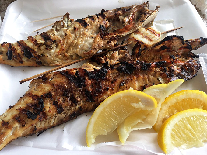 Simplicity at its finest: perfectly grilled fish with lemon wedges. No culinary gymnastics needed when the seafood is this fresh—just fire, fish, and a squeeze of citrus.