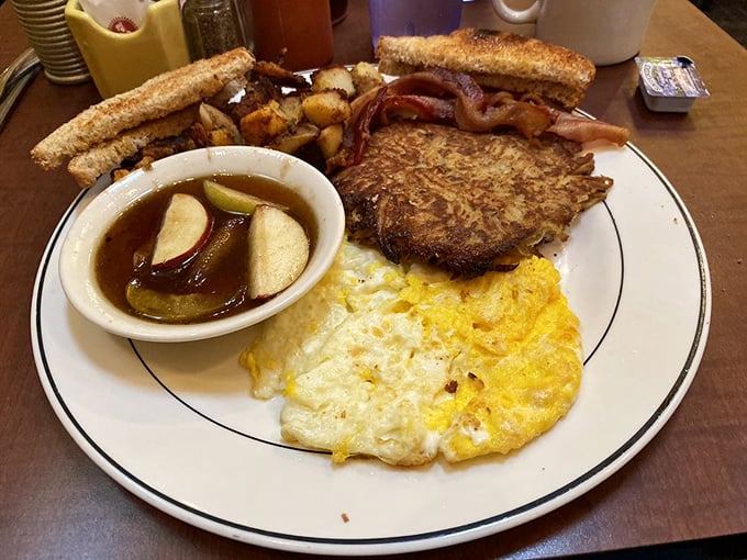 The Grumpy Special: where indecision becomes a virtue. Eggs, potatoes, toast, and what appears to be a potato pancake—because why choose when you can have it all?