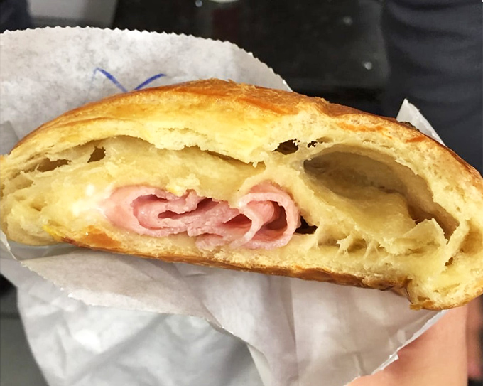 The ham and cheese croissant—where savory meets flaky in a handheld miracle that makes you wonder why breakfast sandwiches need anything else.