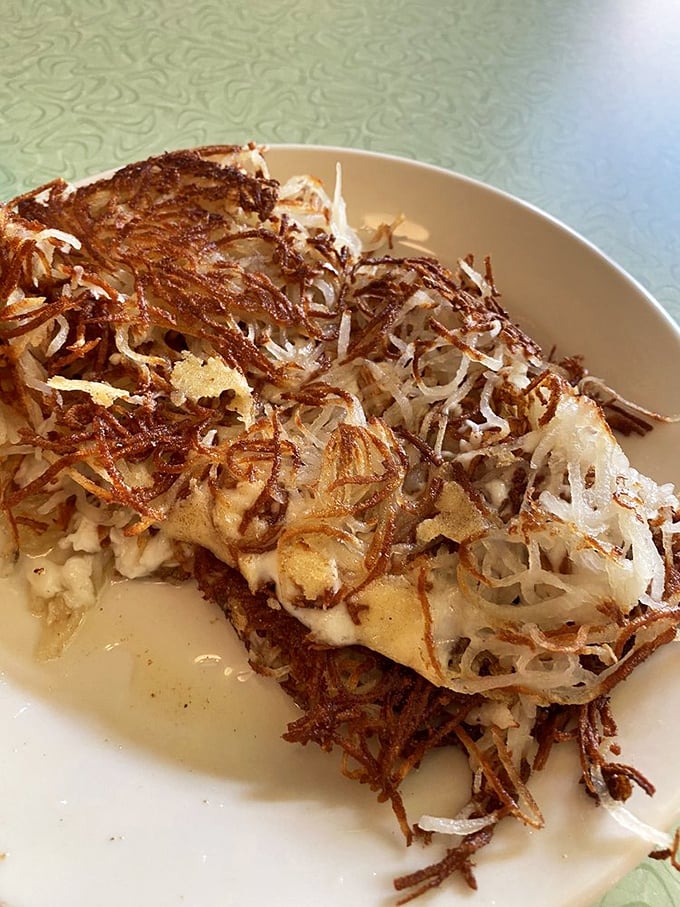 Crispy, golden hash browns that shatter like glass when your fork hits them—these aren't just potatoes, they're a textural revelation.