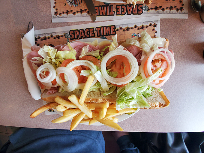 This isn't just a sandwich—it's an open-faced love letter to fresh ingredients, with rings of onion arranged like Olympic symbols atop quality ham.