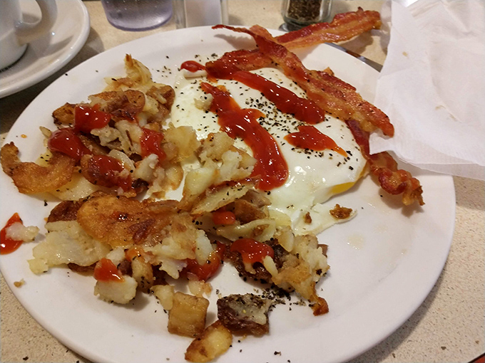 Breakfast potatoes with an identity crisis—part hash browns, part home fries, all delicious. The ketchup zigzag adds that touch of Midwestern abstract expressionism. 