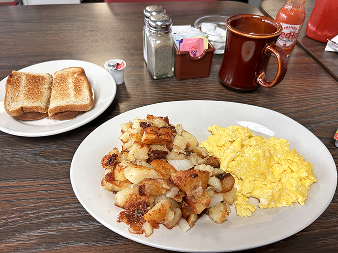 Home fries that actually taste like home—crispy, seasoned potato chunks that have clearly been introduced to a hot griddle by someone who cares.