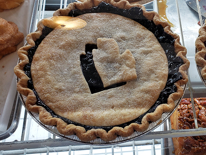 Pie perfection with a Michigan accent. That hand-crimped crust and sugar-dusted top are the telltale signs of someone who knows their way around pastry.