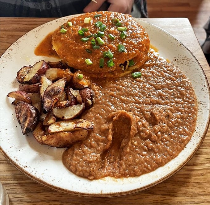Breakfast with attitude. This hearty plate with its rich sauce and roasted potatoes doesn't just start your day—it launches it into the stratosphere.