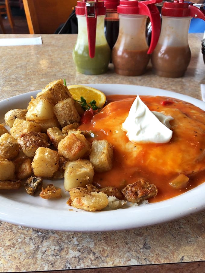 This isn't just huevos rancheros—it's breakfast wearing a party hat. Vibrant sauce, crispy potatoes, and that dollop of sour cream that says "Good morning, gorgeous."