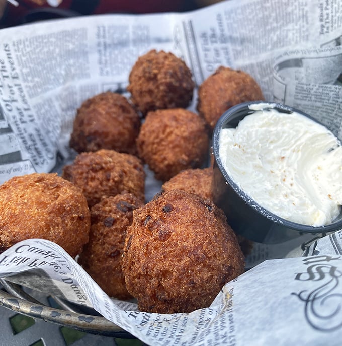 Hush puppies so perfectly golden they should come with a warning: "May cause involuntary food noises." That creamy dipping sauce is calling your name.