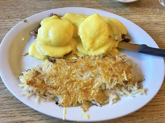 Eggs Benedict's sophisticated cousin has arrived. Golden hollandaise cascades over perfectly poached eggs while crispy hash browns stand ready for action.