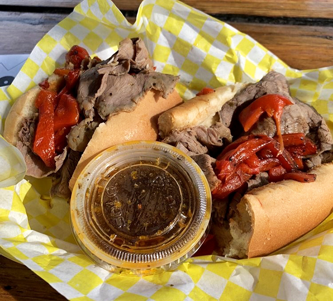 Italian beef sandwich with au jus for dipping—the kind that requires the "Chicago lean" to avoid wearing it home. Worth every napkin.