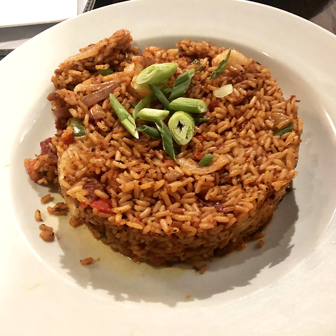Charleston red rice, shaped into a perfect dome and crowned with scallions—proof that side dishes can steal the spotlight with enough personality.