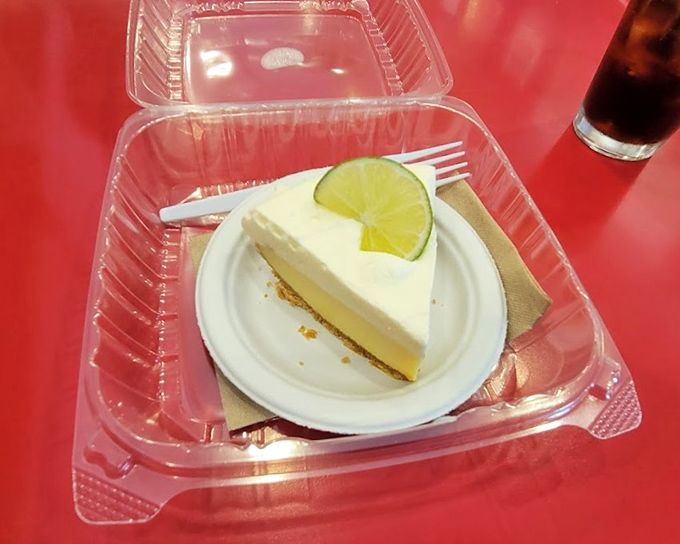 Key lime pie so authentic it should come with a tiny Florida passport—that lime wedge garnish is like a wink from the dessert itself.