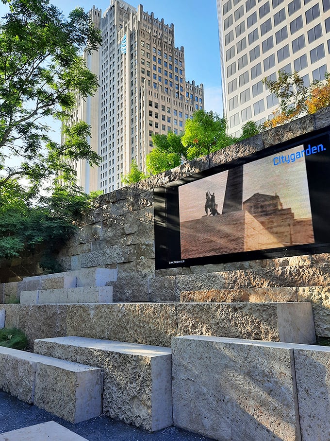 The park's video wall brings digital artistry to the limestone amphitheater. Technology and nature coexist beautifully, with St. Louis' historic architecture framing the scene.