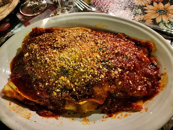 The lasagna that launched a thousand road trips. Those layers aren't just pasta and cheese—they're edible architecture.