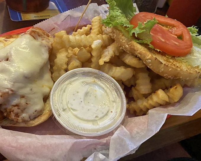 A sandwich that encourages laziness? Count me in! Crispy chicken nestled between fresh veggies and melty cheese – worth every napkin.