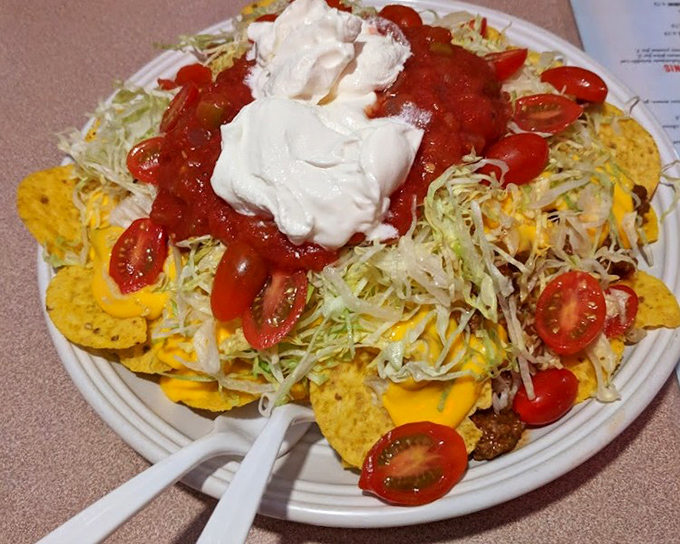 Nachos that require a strategy to eat—each chip a potential vehicle for the perfect ratio of cheese, salsa, and sour cream.
