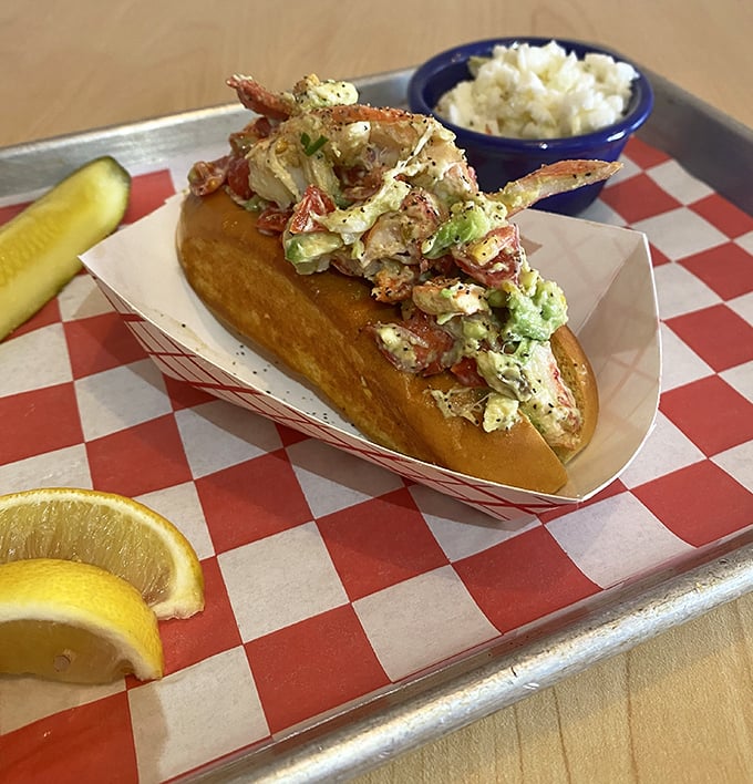 Lobster roll perfection—sweet chunks of seafood treasure nestled in a buttery vessel. That side of creamy slaw is the unsung hero of this plate.