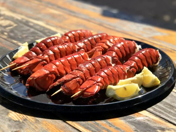 Lobster tails on skewers—nature's way of saying "here's the good stuff, no shell-cracking required." The lemon wedges aren't garnish; they're essential supporting actors.