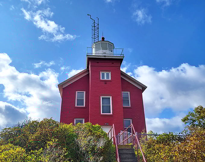 The crimson Marquette Harbor Lighthouse stands sentinel over Superior's waters, a splash of bold color against Michigan's most dramatic horizon.
