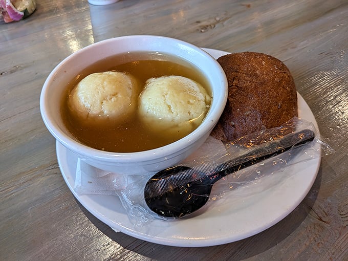 Matzo ball soup that would make your grandmother nod in approval—golden broth cradling fluffy dumplings like edible clouds of comfort.