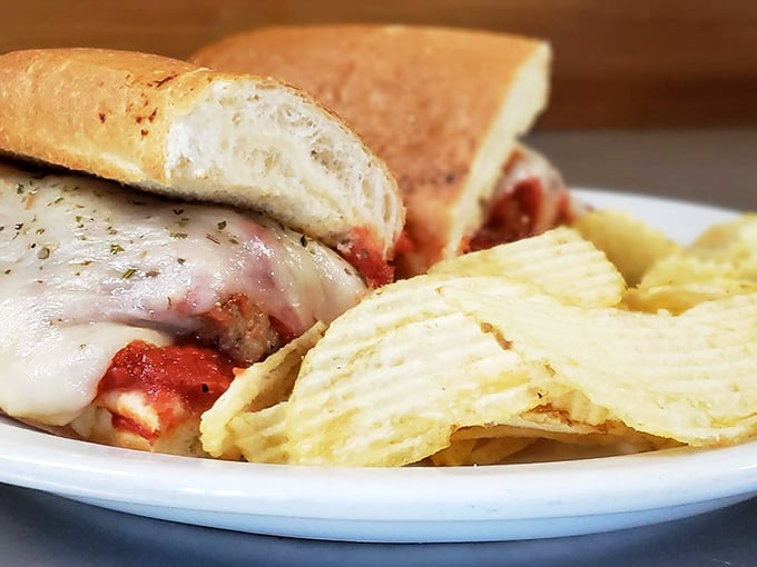 The meatball sub arrives like a delicious argument against dainty eating, with melted cheese cascading down the sides like a dairy waterfall.