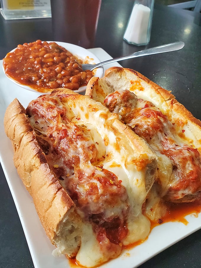 A meatball sub that demands both hands and your undivided attention. Those beans on the side aren't just playing backup—they're part of the band.