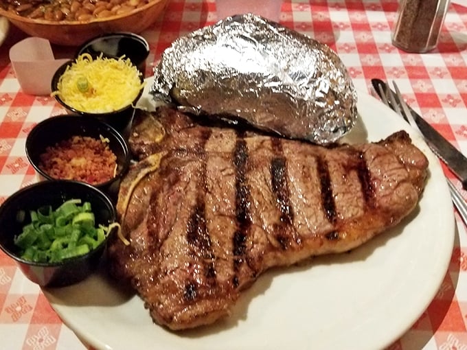 Steak perfection doesn't need fancy sauces—just fire, skill, and respect for the meat. The foil-wrapped potato stands by, ready for duty.