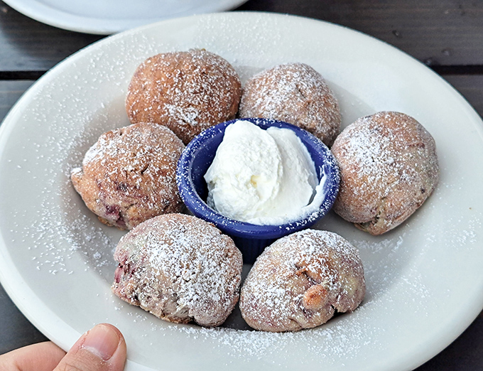 These powdered mini scones with clotted cream aren't just pastries – they're time machines to afternoon tea with your imaginary British grandmother.